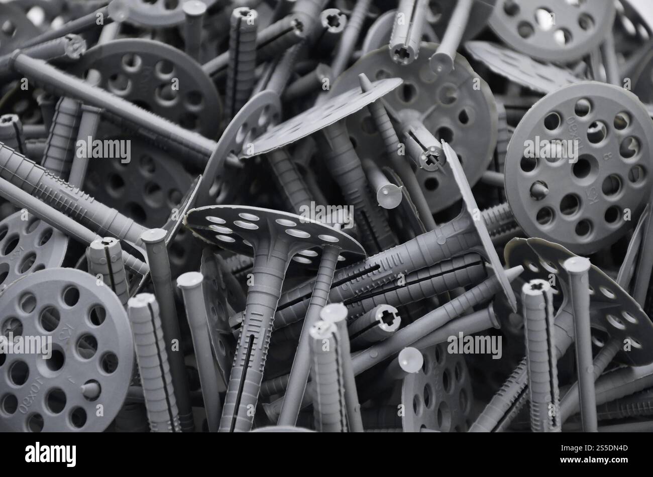Background pattern of many gray plastic dowels fastening for thermal ...