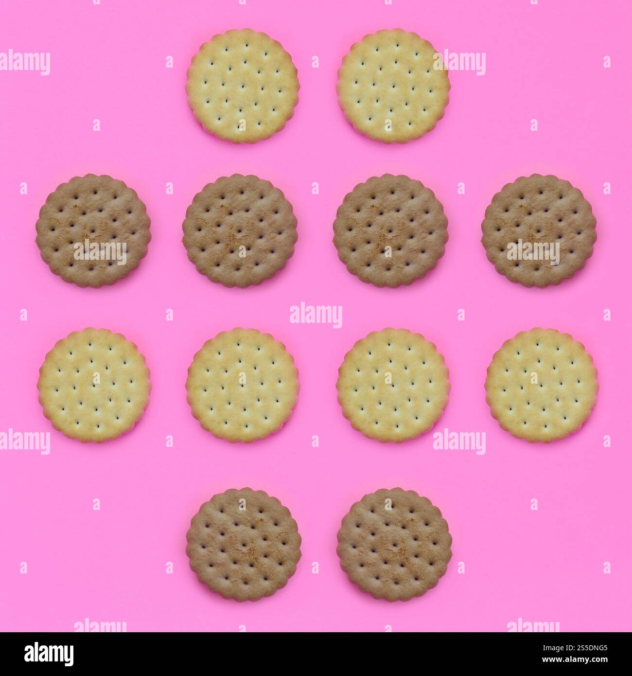 Pattern of a brown biscuits on a pink background. Trendy minimal ...