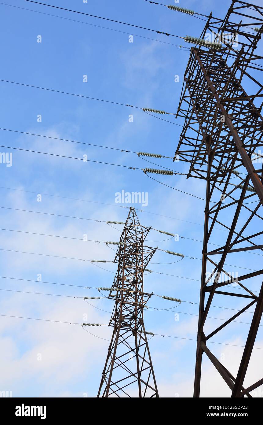The silhouette of the electricity transmission pylon in daytime ...
