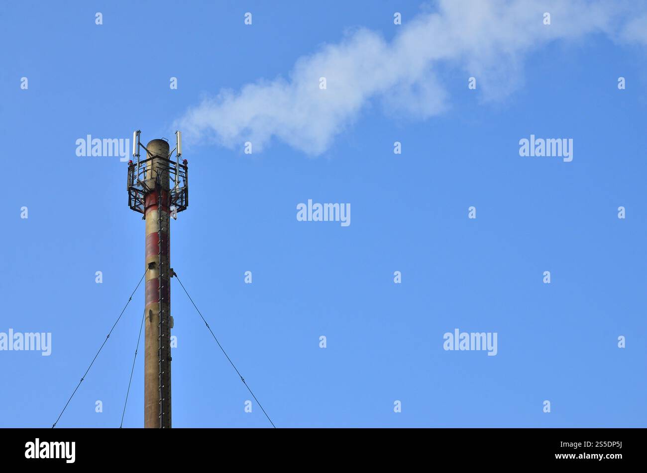 Chimney steam pipe of industrial manufacturing plant. High chimney of ...