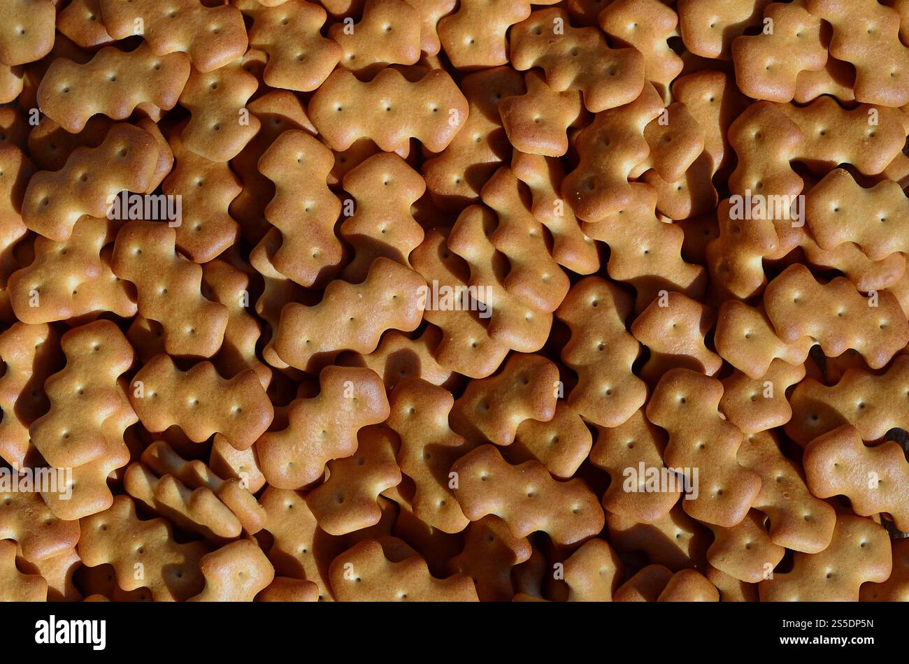 A huge bunch of salted biscuits of small sizes as a closed pattern or ...
