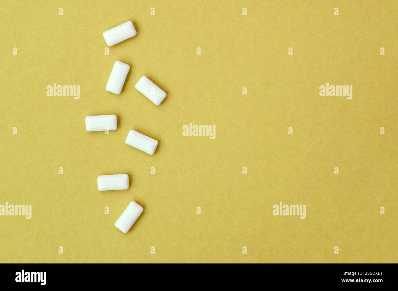 A few chewing gums lie on texture background of fashion pastel orange ...