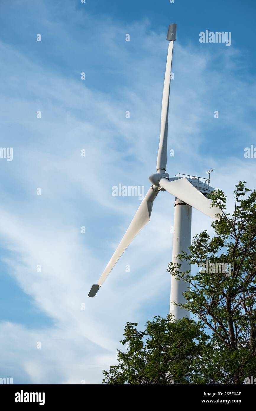 Offshore windmill turbine with blue sky background. Wind turbine Green ...