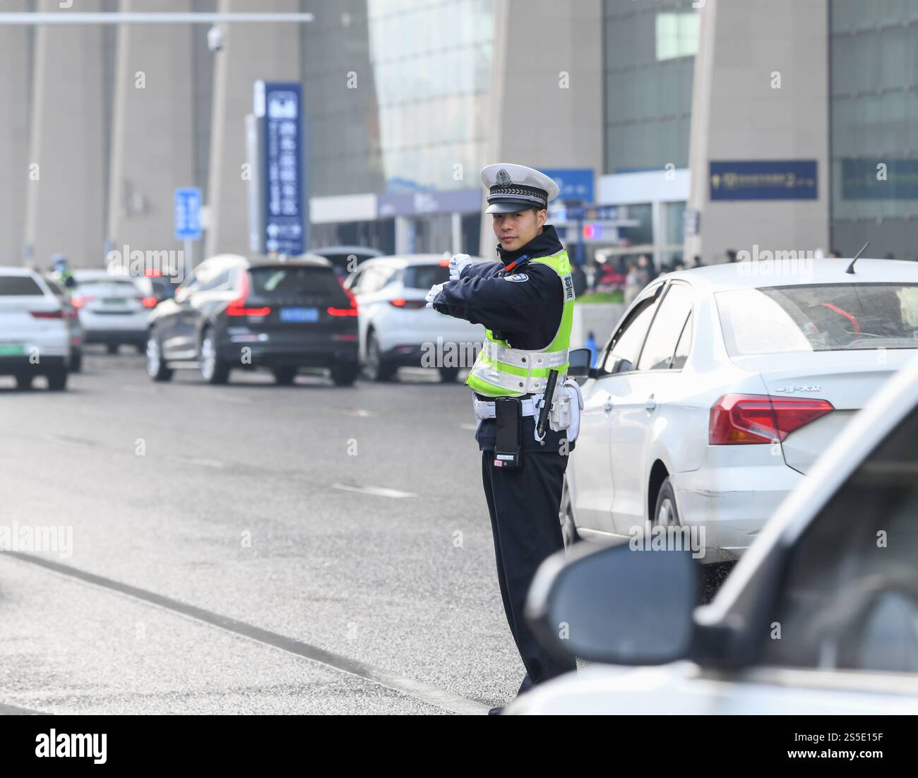 Chengdu, China's Sichuan Province. 14th Jan, 2025. A police officer directs traffic outside ...
