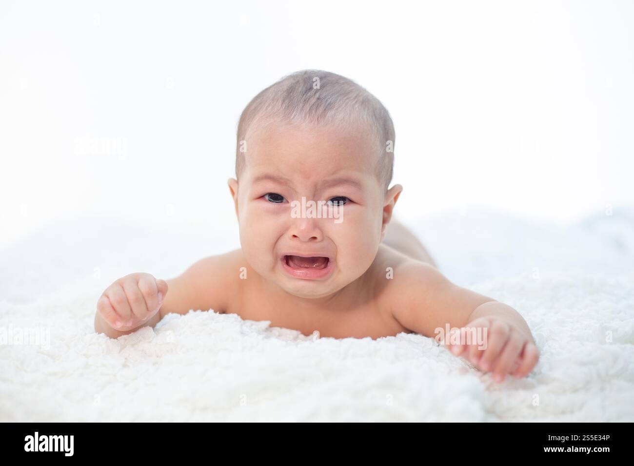 Babies are sad on the bed Stock Photo - Alamy