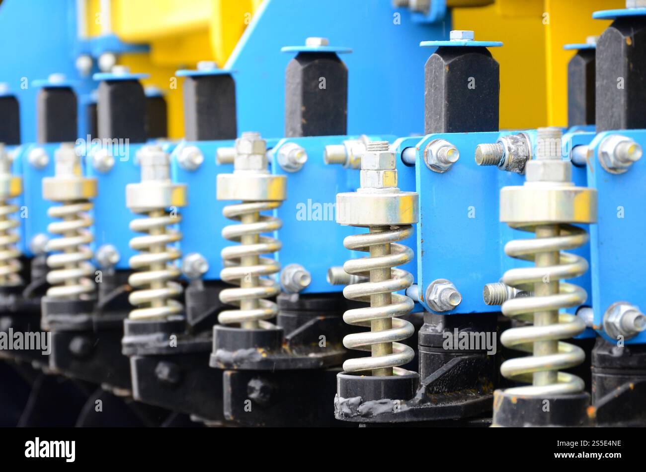 Spring system of agricultural seeder close up Stock Photo - Alamy