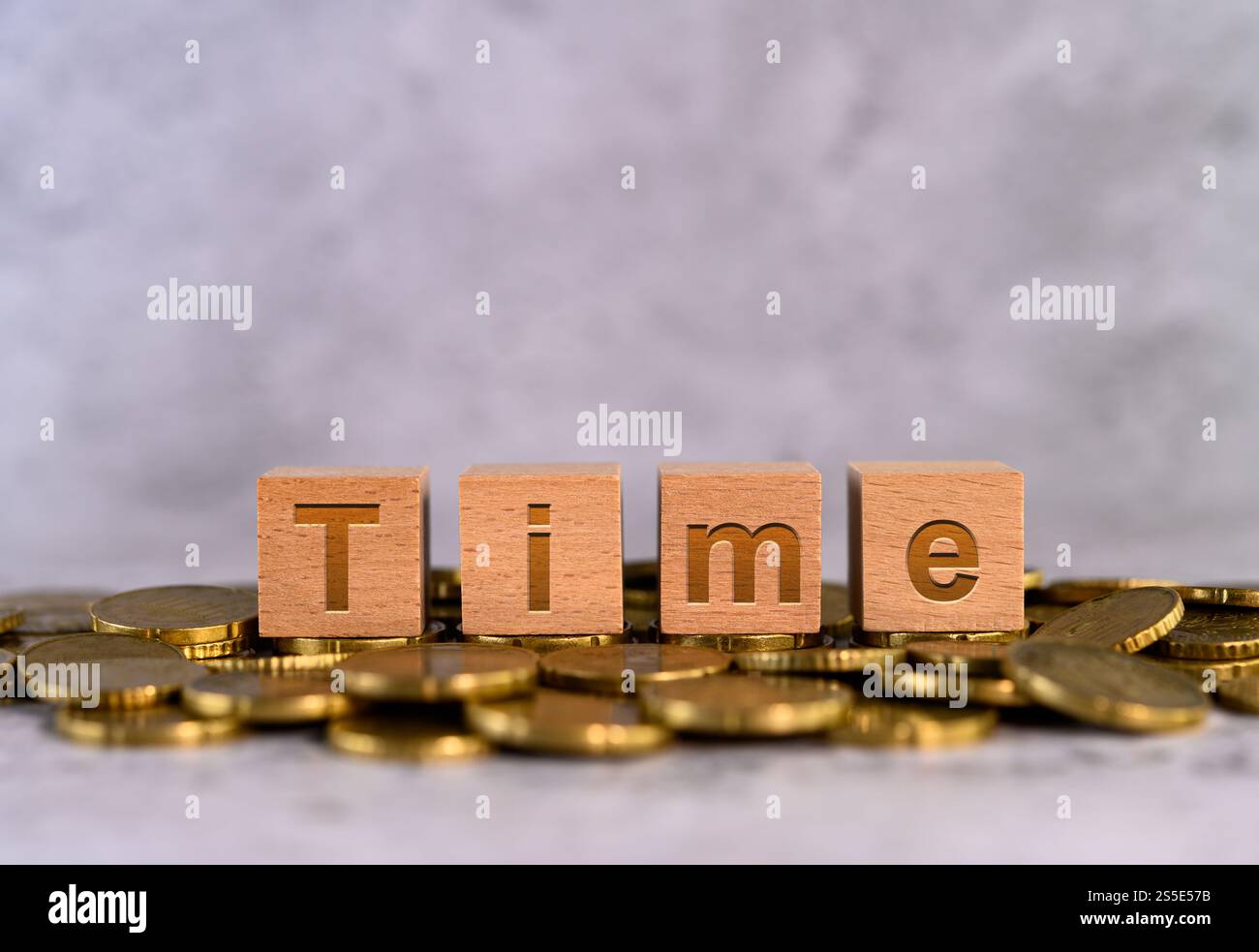 Time word alphabet wooden cube letters placed on a gold coin Stock ...