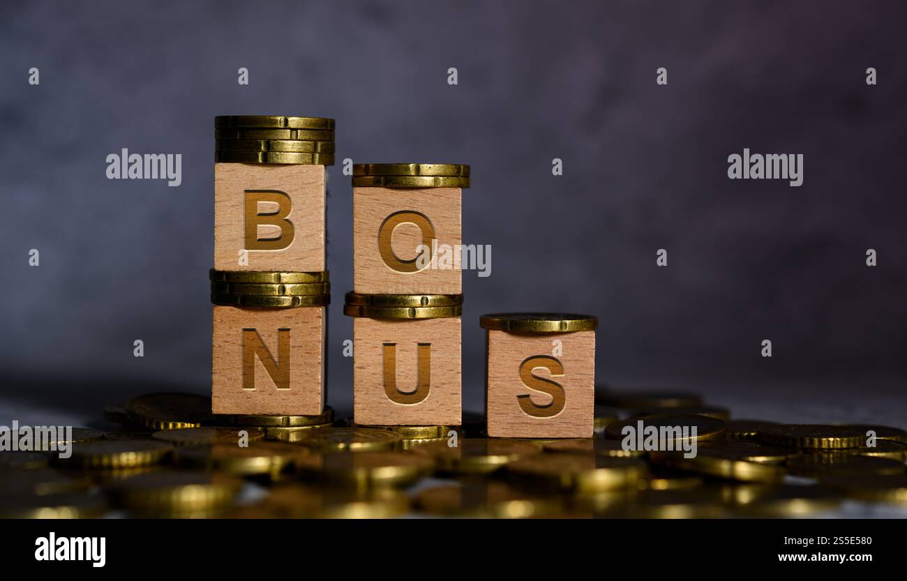 Bonus word alphabet wooden cube letters placed on a gold coin Stock ...