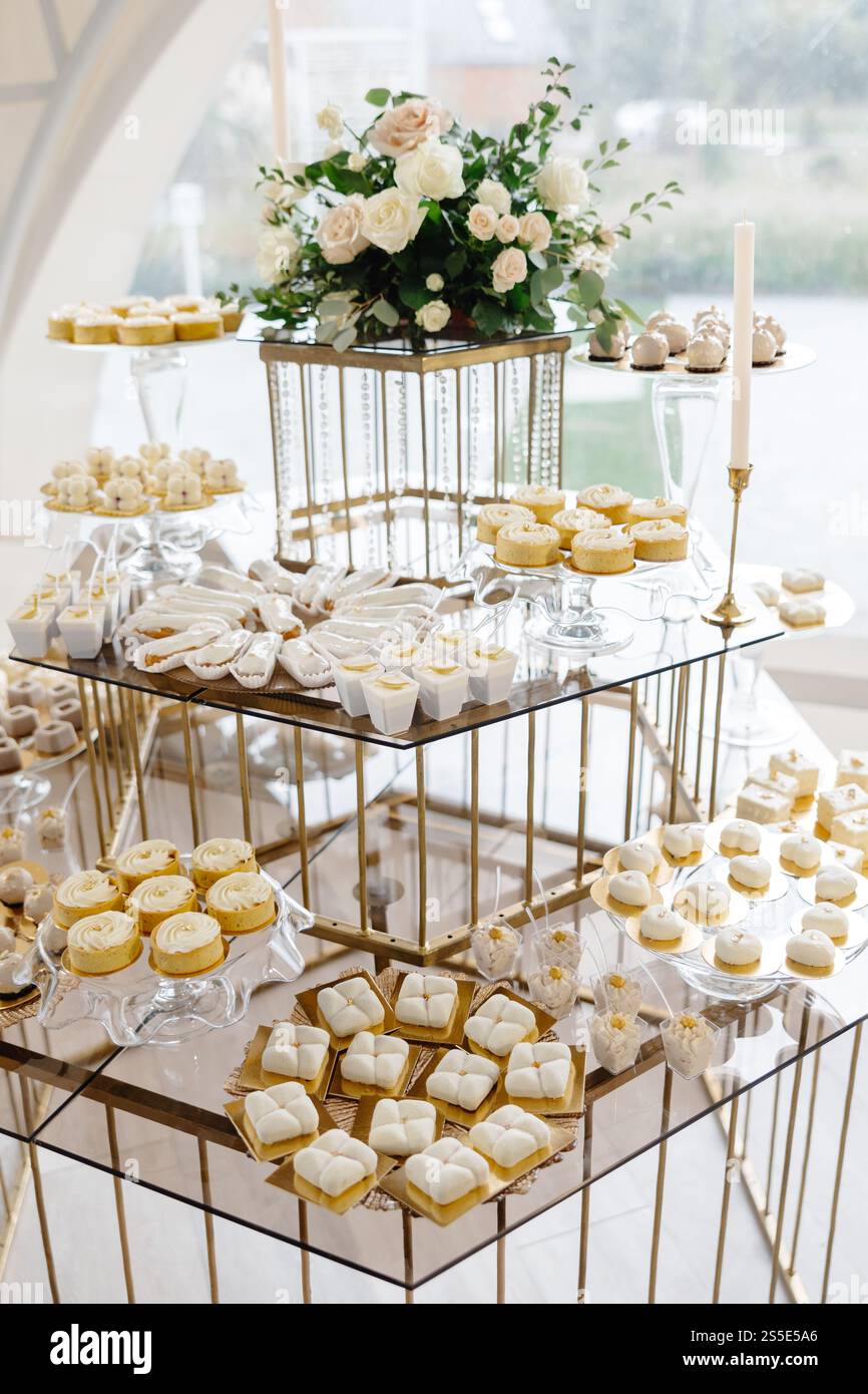 Catering service preparing a table for a wedding reception, putting ...