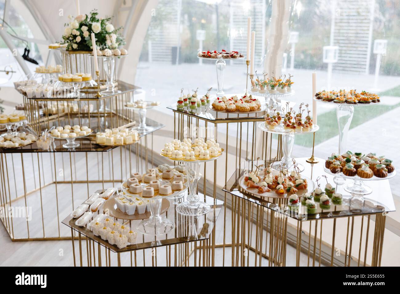 Catering service preparing a table for a wedding reception, putting ...