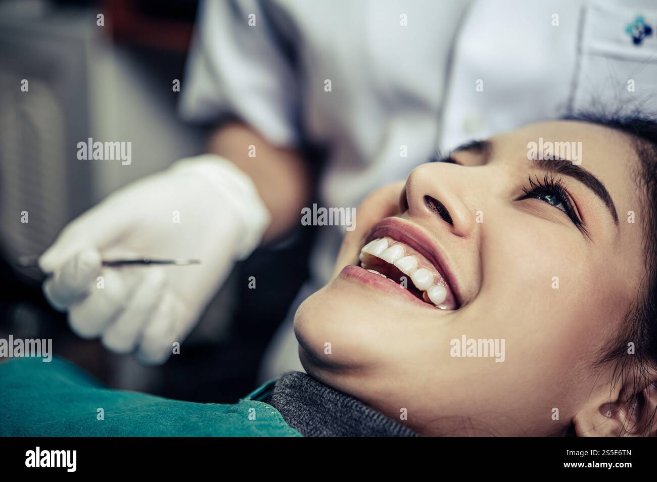 The dentist examines the patients teeth Stock Photo - Alamy