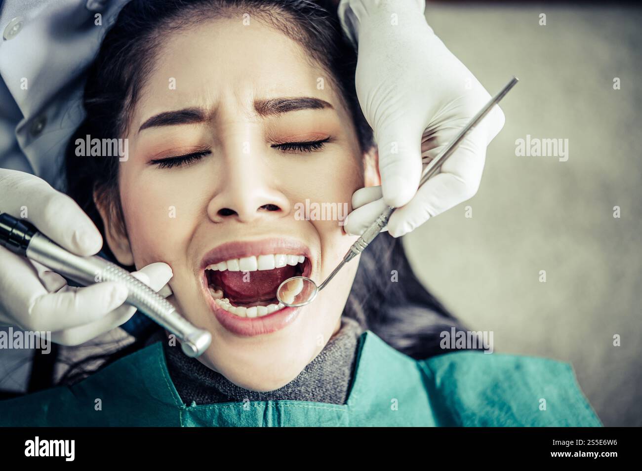 The dentist examines the patients teeth Stock Photo - Alamy