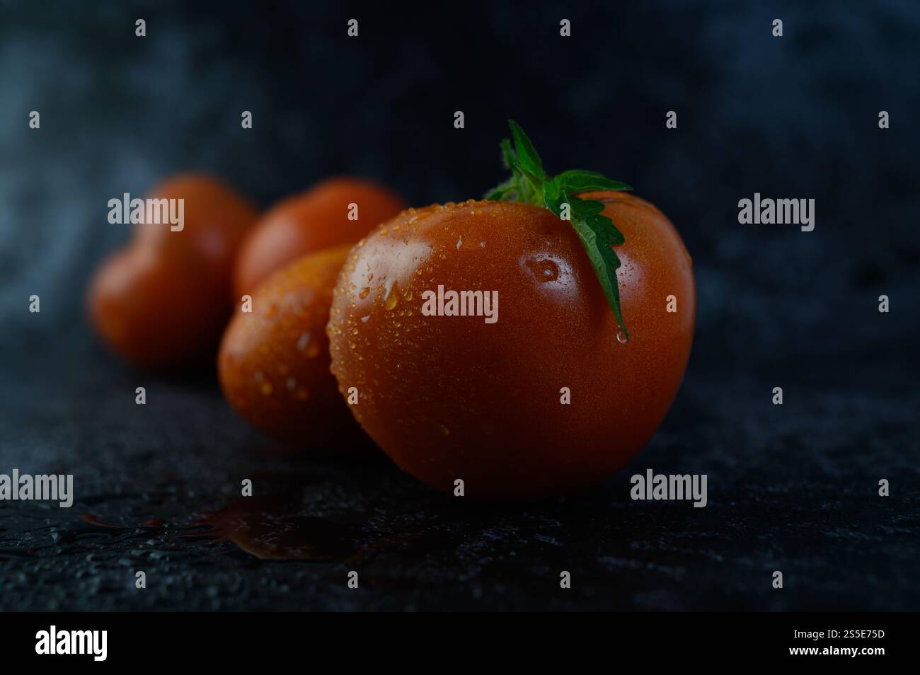 Organic tomato with water droplets in closeup macro Stock Photo - Alamy