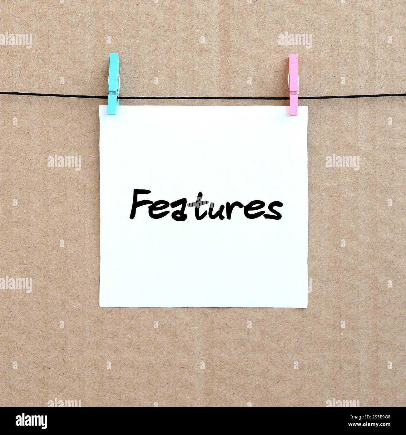 Features. Note is written on a white sticker that hangs with a ...