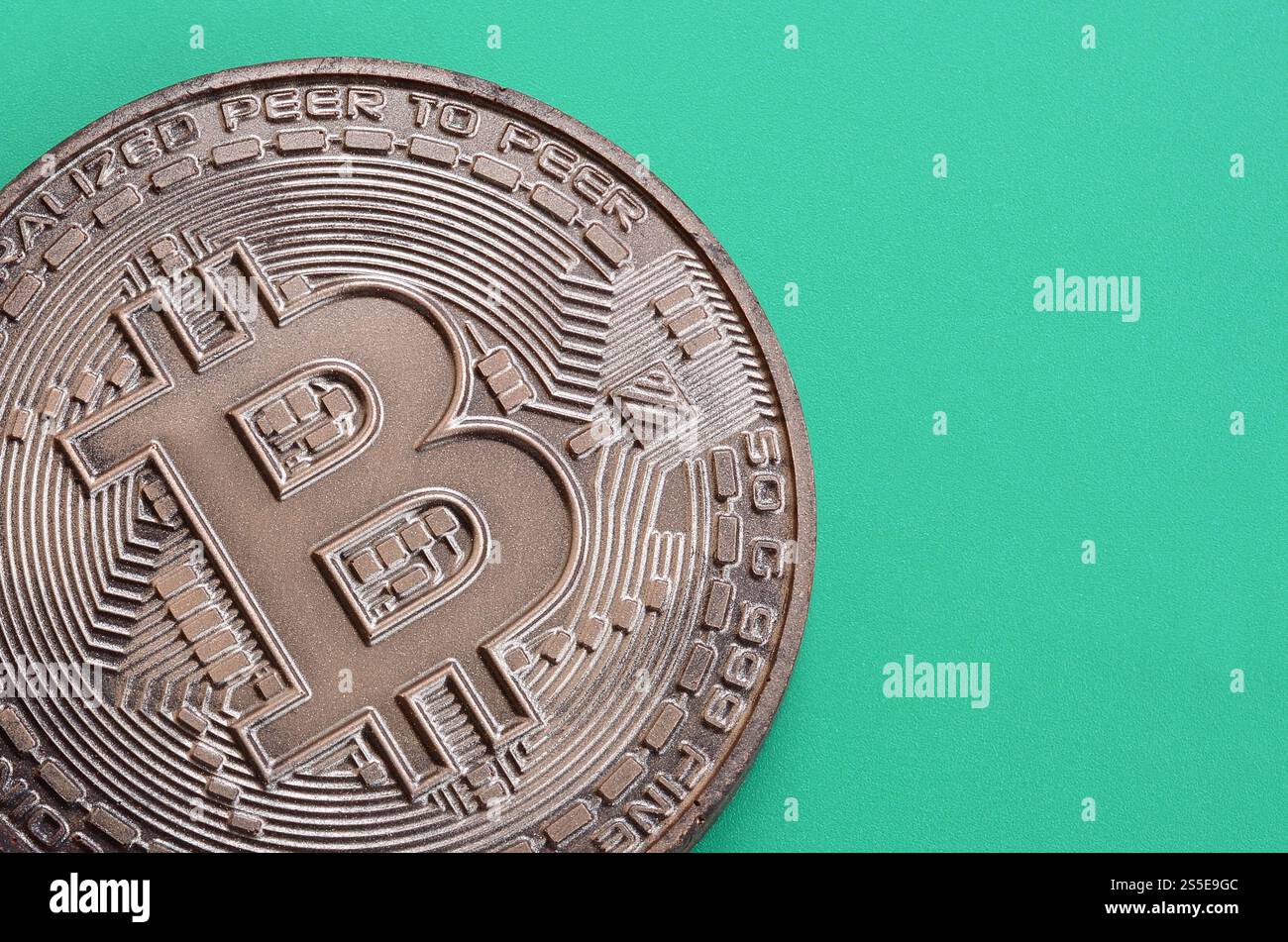 Chocolate product in the form of physical bitcoin lies on a green ...