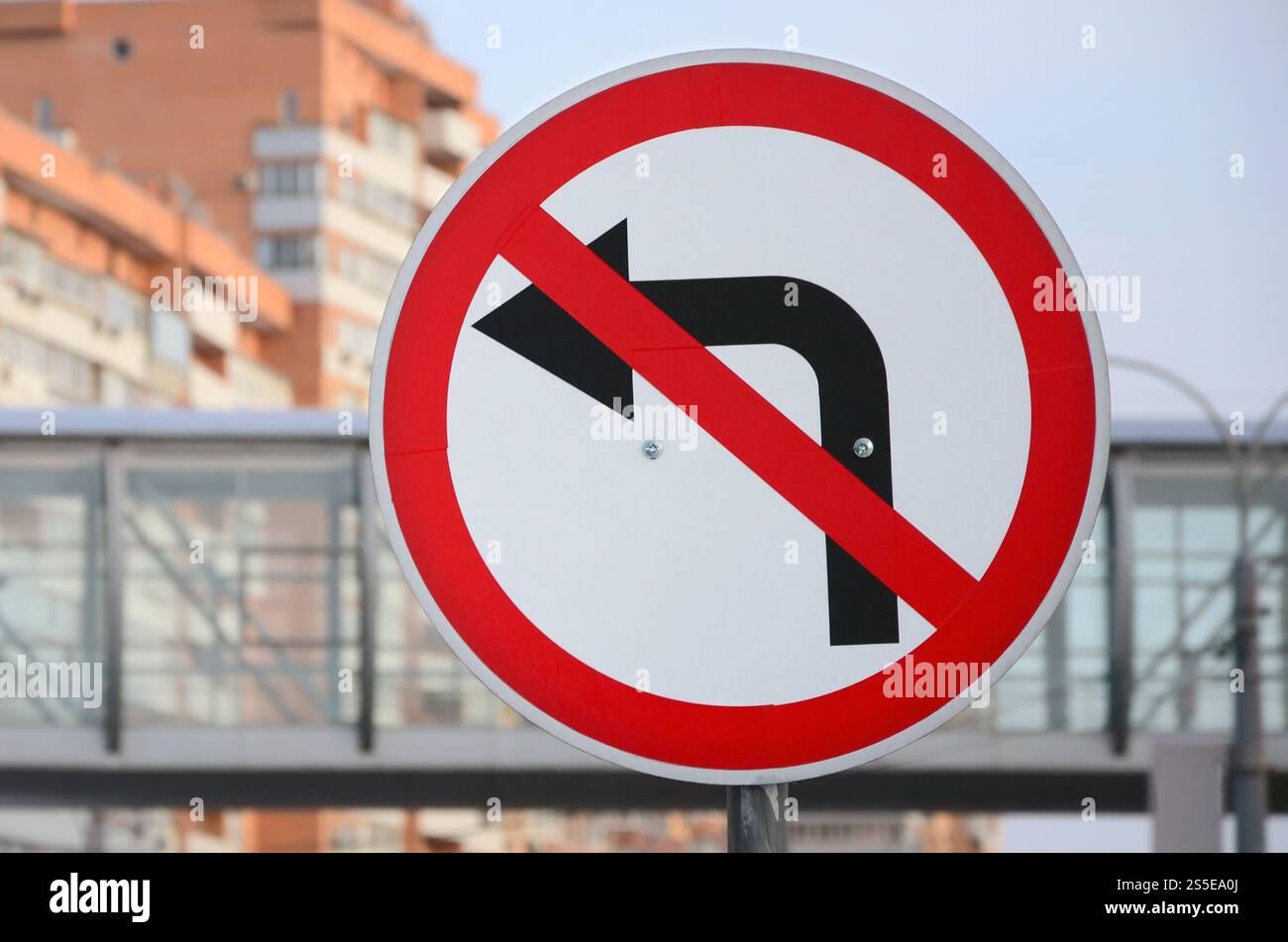 Turn left is prohibited. Traffic sign with crossed out arrow to the left Stock Photo - Alamy
