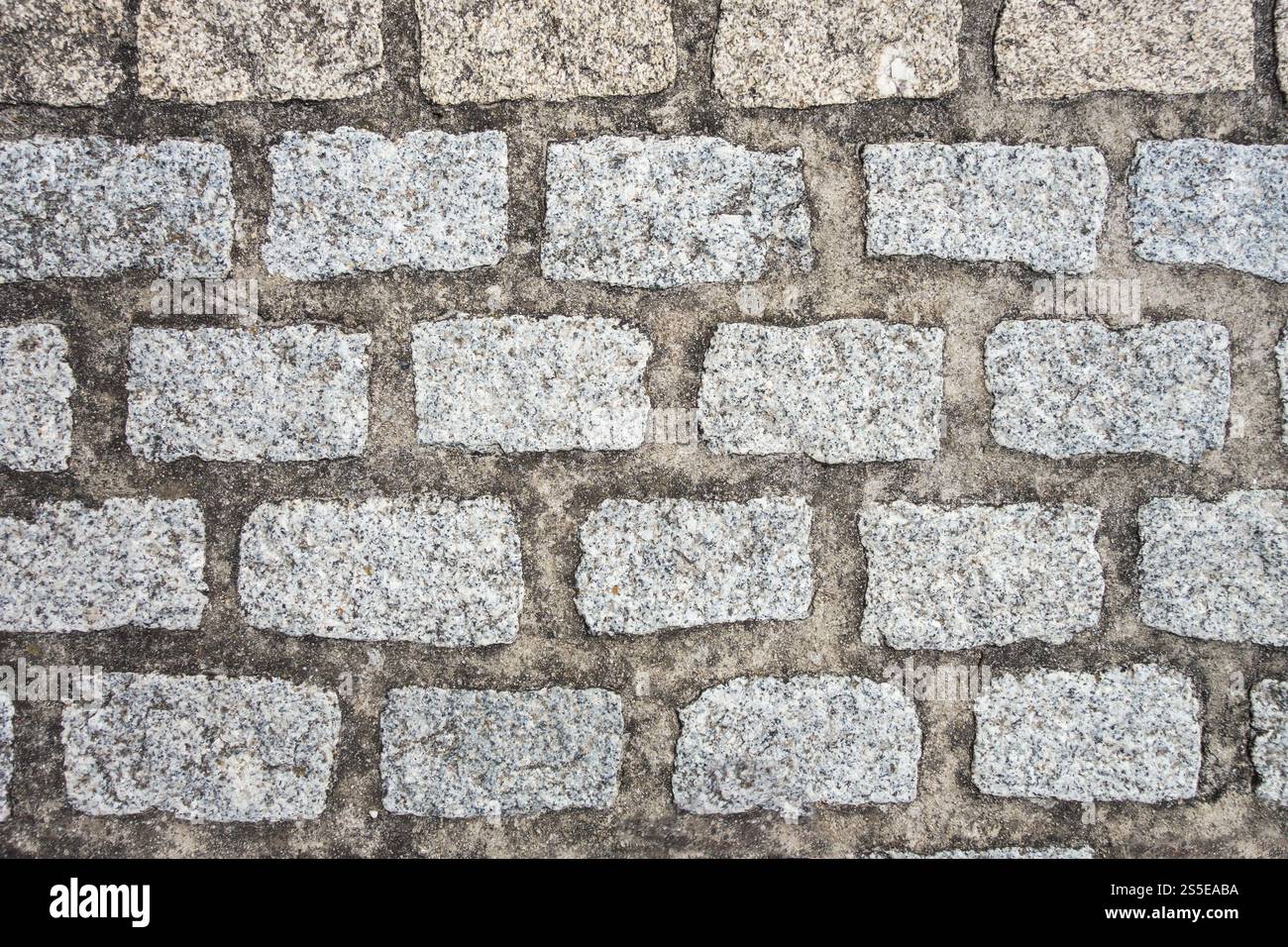 Old cobblestone pavement background texture. Closeup view. Old cobblestone pavement background ...