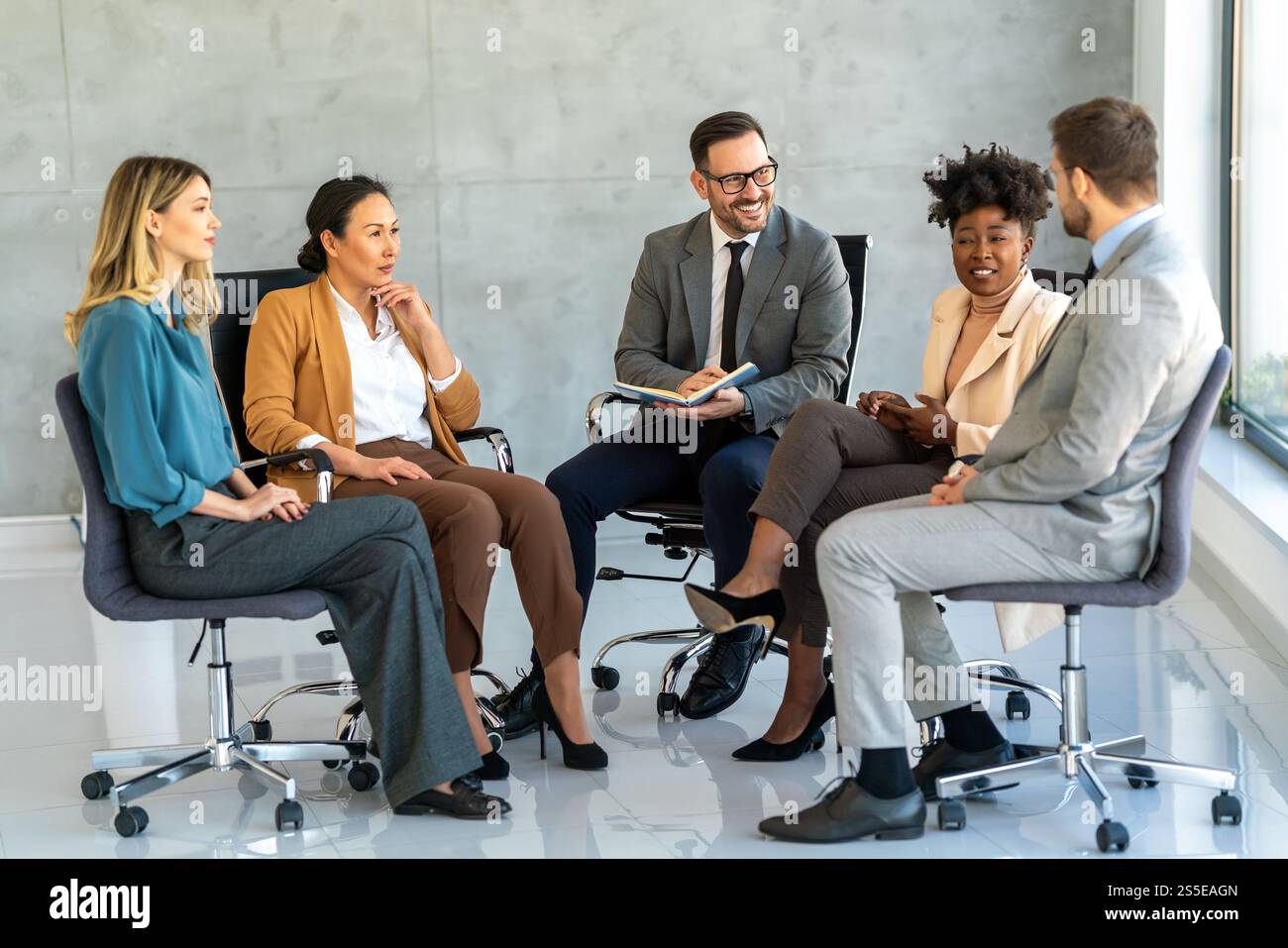Group therapy. Multiethnic professional people sitting together while ...