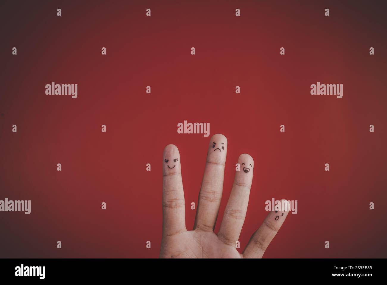 Finger with emotion on red background Stock Photo - Alamy