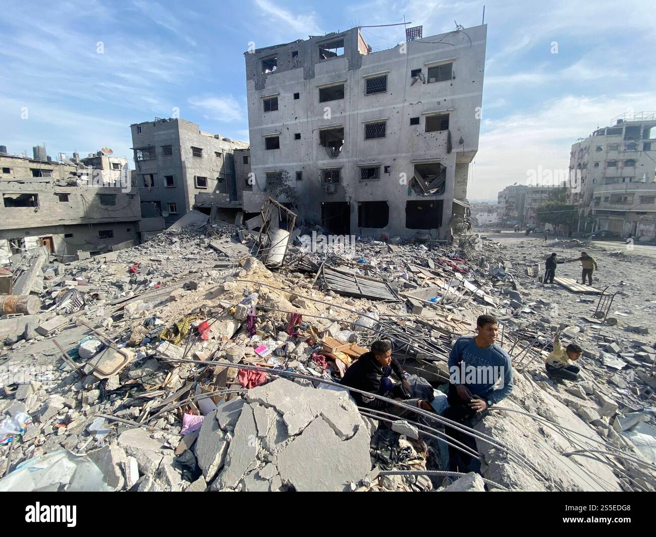 Residents inspect buildings damaged in the Israeli attack, in Gaza City ...