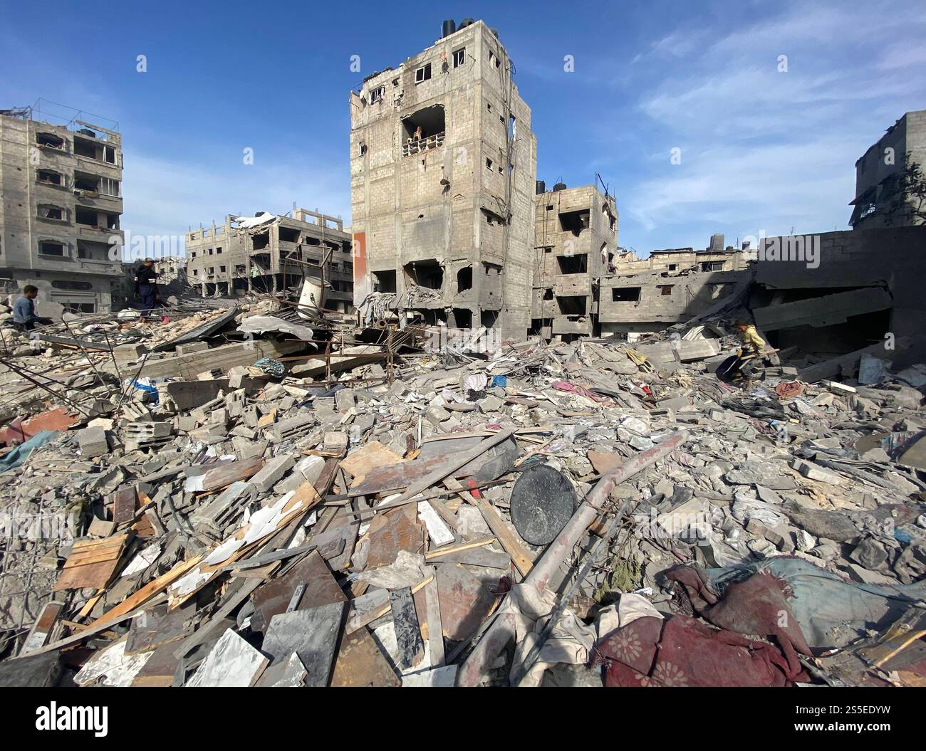 Residents inspect buildings damaged in the Israeli attack, in Gaza City ...