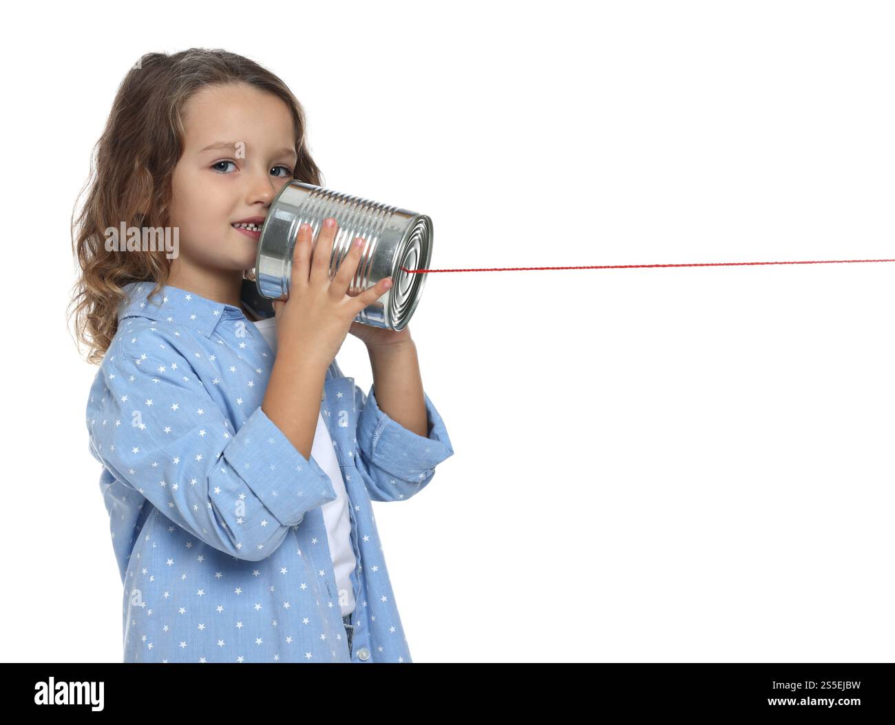 Girl using tin can telephone on white background Stock Photo - Alamy