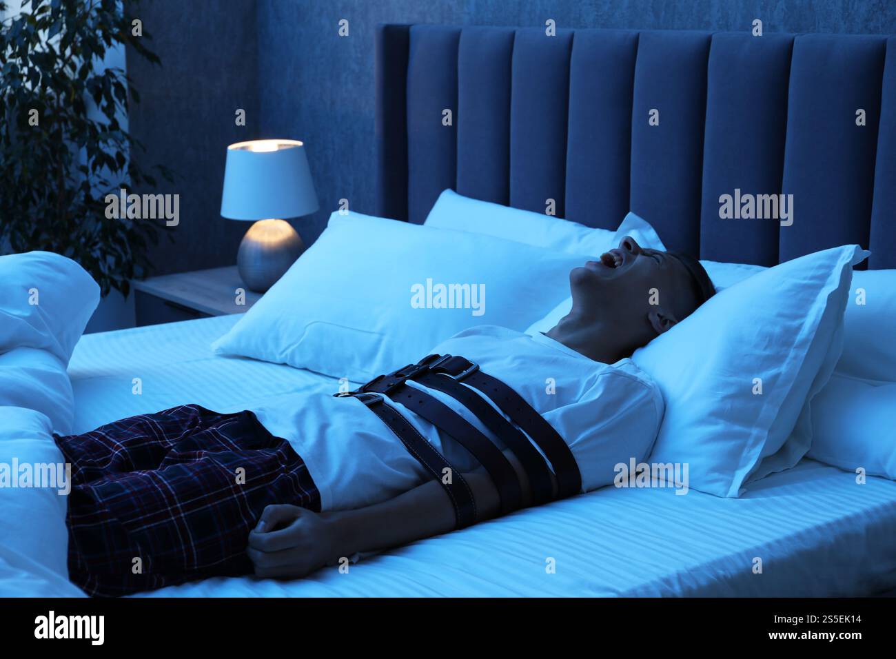 Man in sleepwalking condition screaming on bed Stock Photo - Alamy