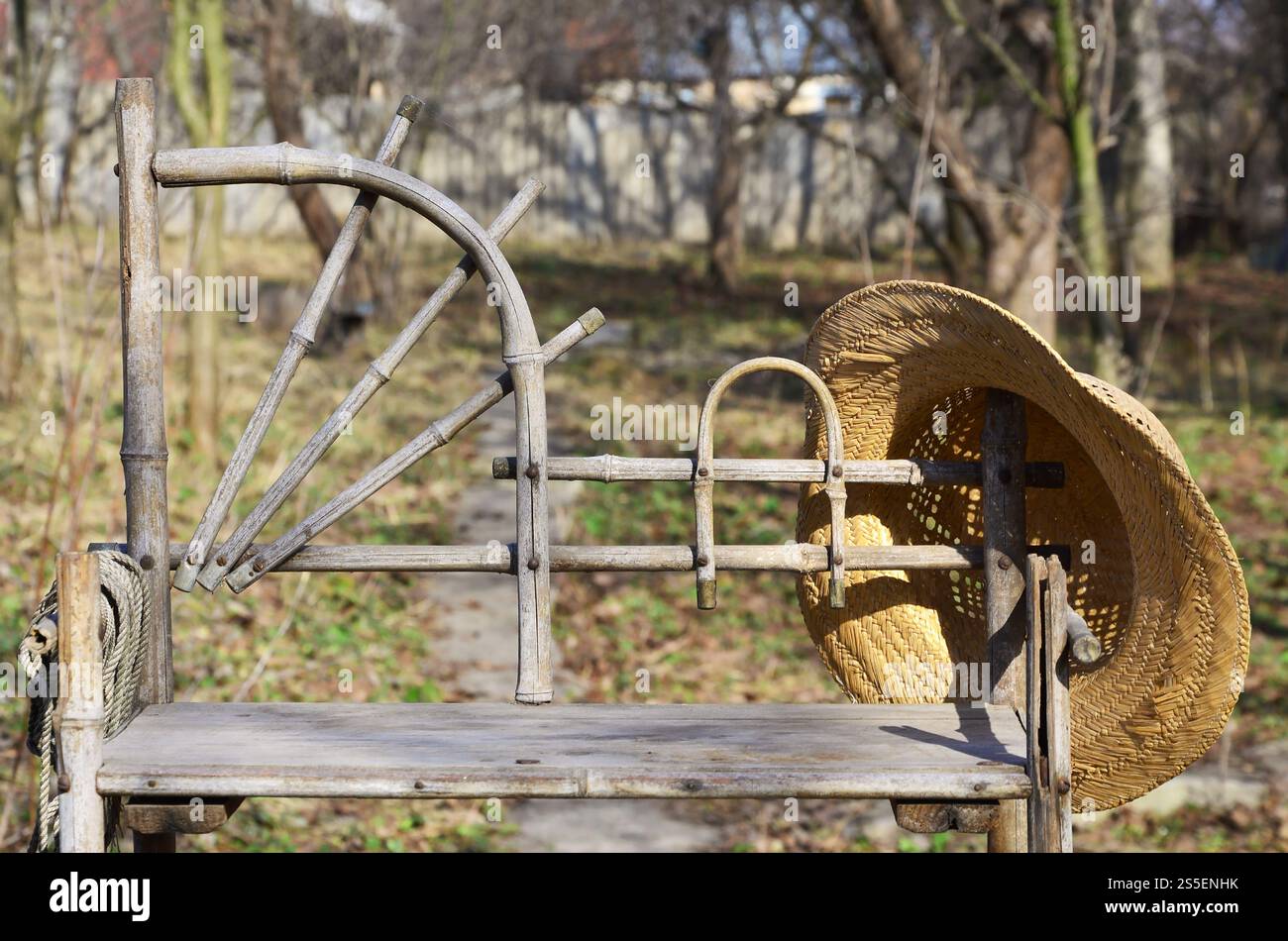 A rustic still-life with a straw hat on a wooden hand-made shelf made ...