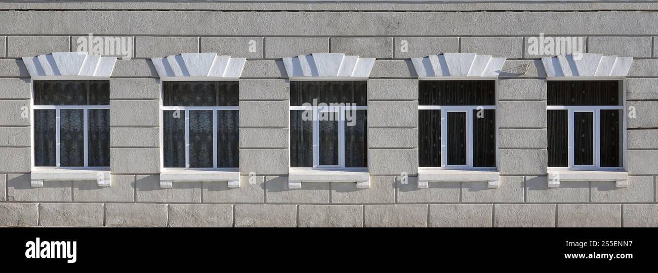 Texture of a glazed modern windows of a grey concrete building. Close ...