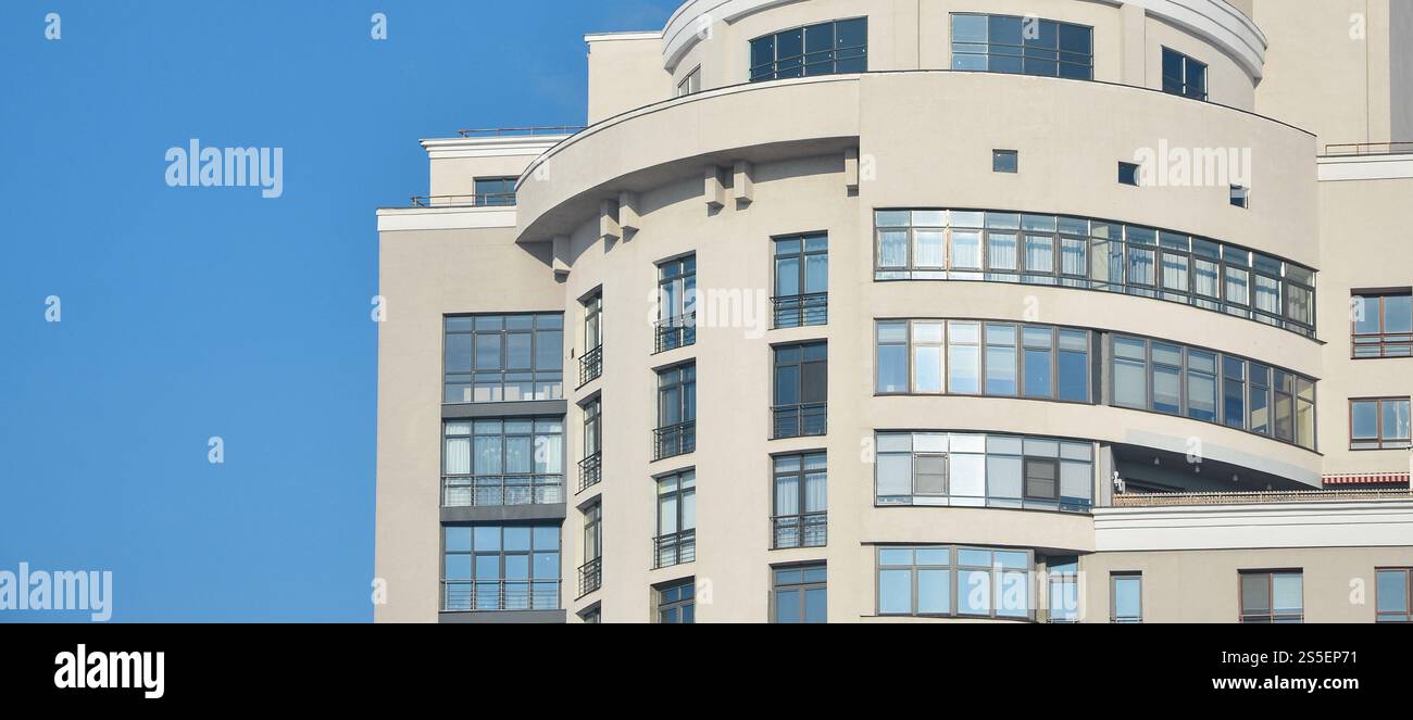 Multi-story office building beige color with lots of glass windows on a ...