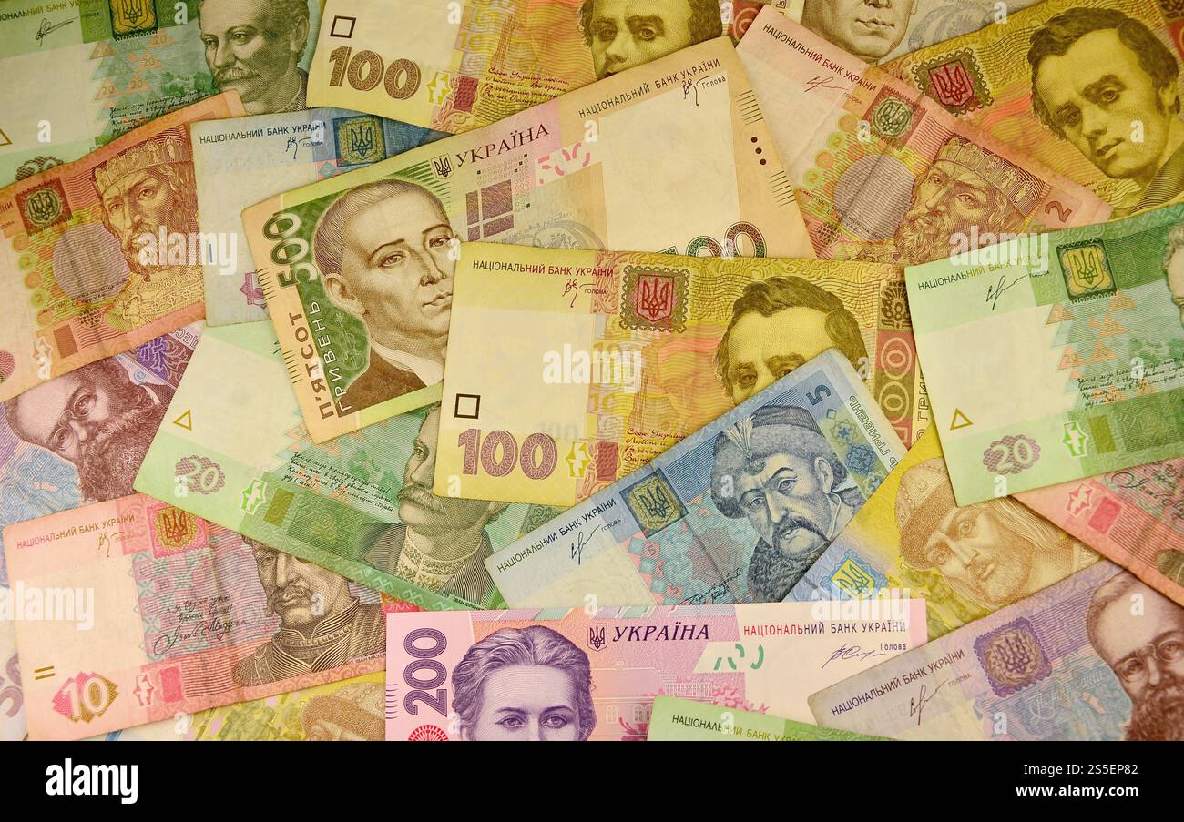 The background image of a pile of Ukrainian banknotes of different ...