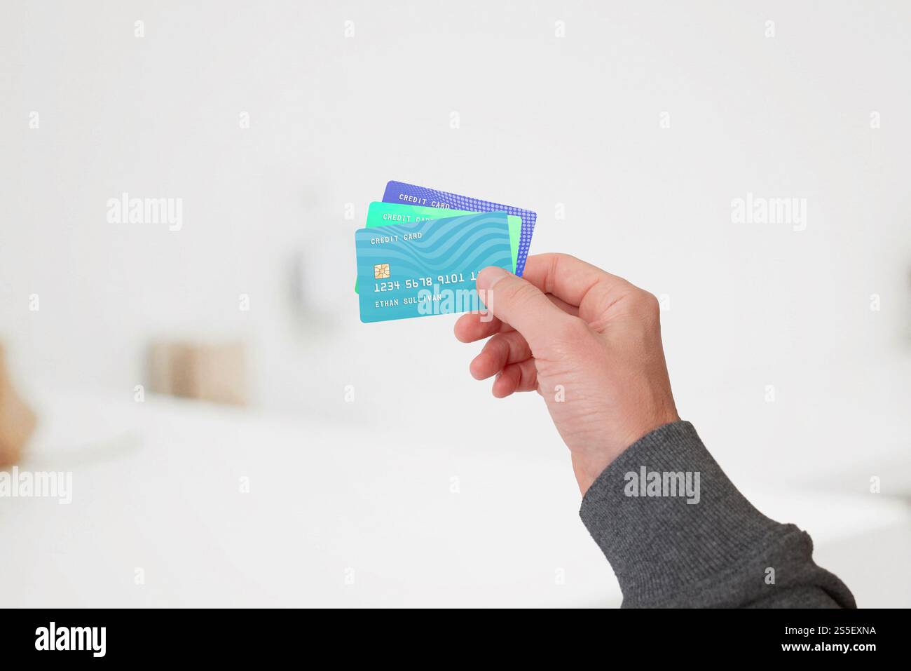 Hand holding three different credit cards, symbolizing the complexity ...
