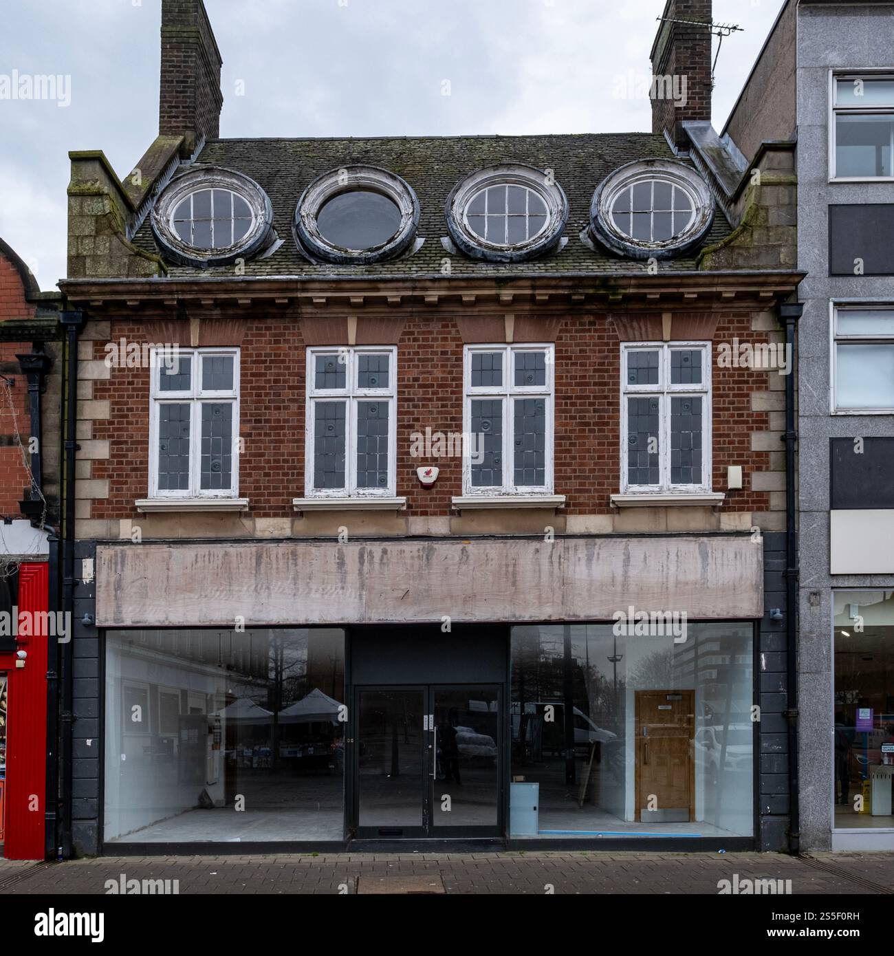 Closed down shop, with removed shop signs, in town centre of Crewe ...