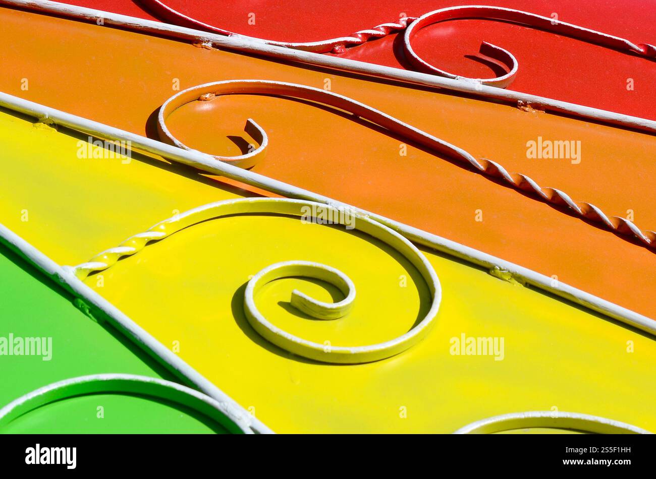 Metal texture of a piece of colored wall with a forged pattern. Rainbow ...