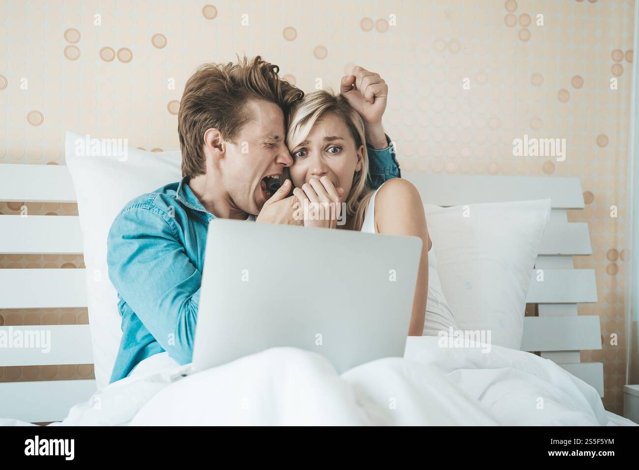 Happy couple Using laptop computer on the bed Stock Photo - Alamy