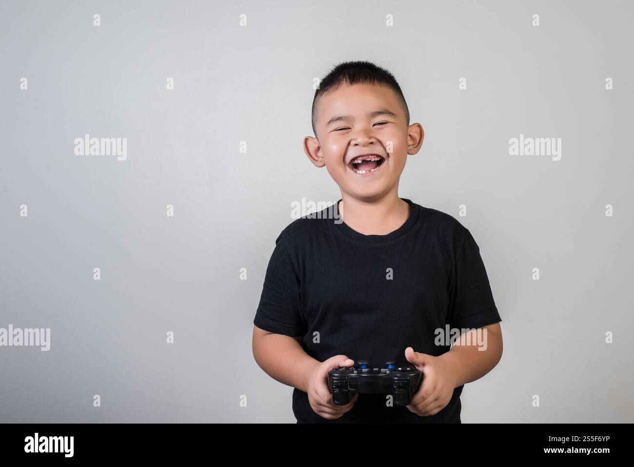 Happy boy play game computer with a controller in studio photo Stock ...
