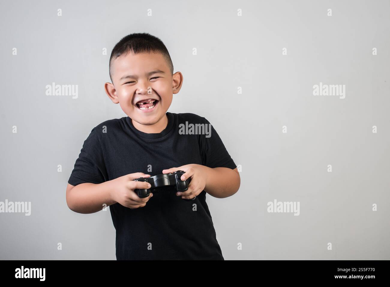 Happy boy play game computer with a controller in studio photo Stock ...