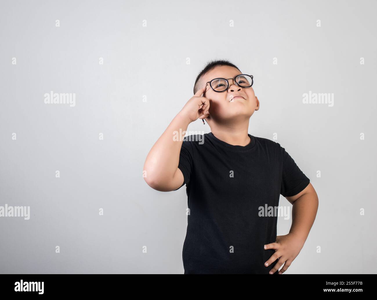 Funny Genius boy Thinking in studio shot Stock Photo - Alamy