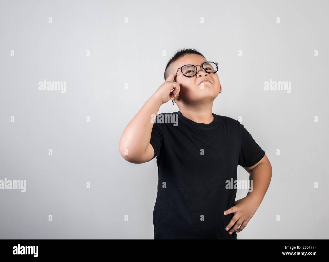 Funny Genius boy Thinking in studio shot Stock Photo - Alamy