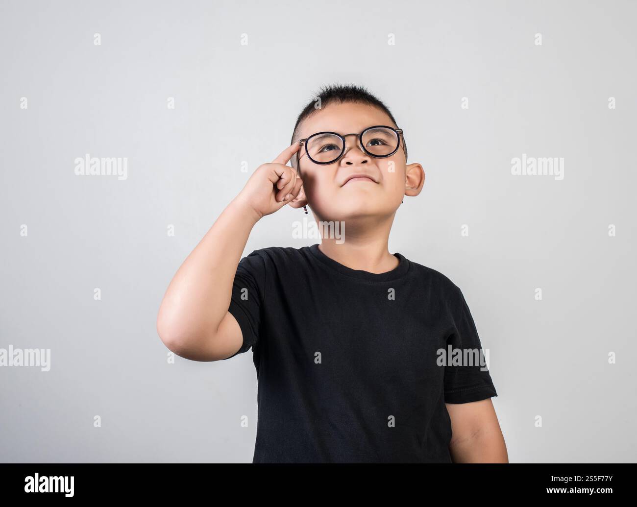 Funny Genius boy Thinking in studio shot Stock Photo - Alamy