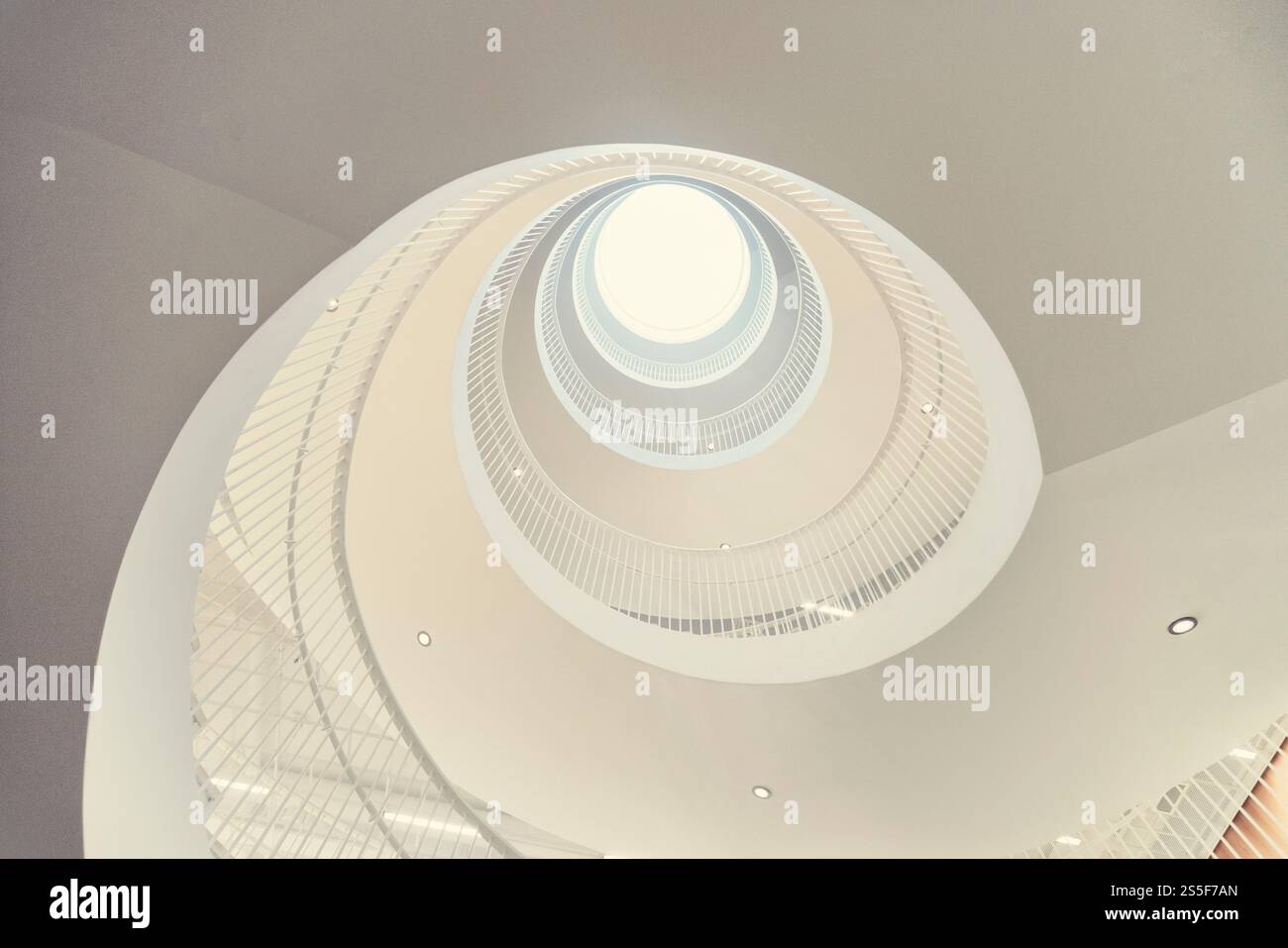 White spiral staircase leading up round skylight modern building hi-res ...