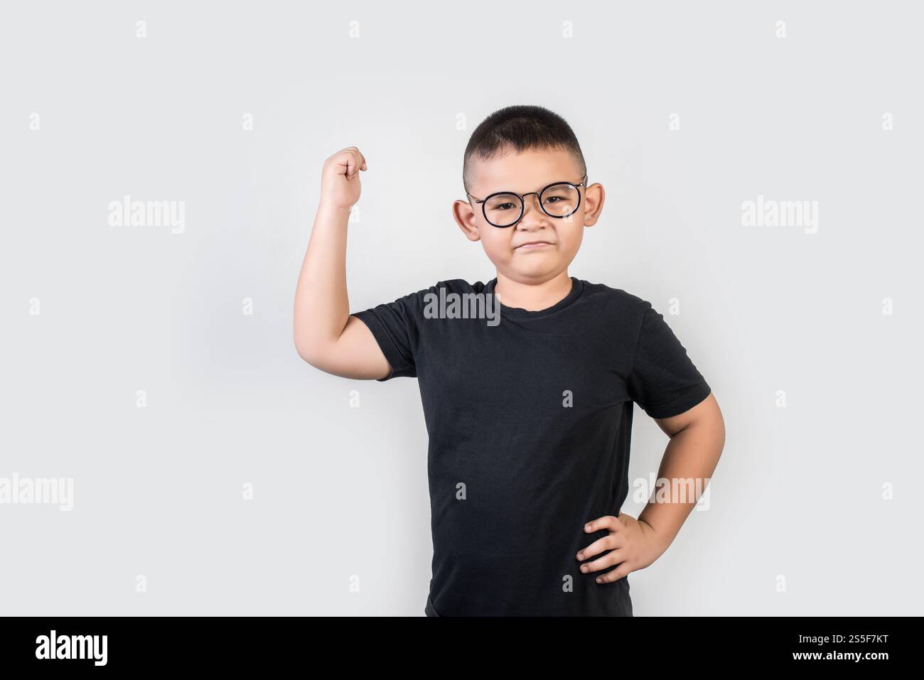 Boy showing his muscle power up Stock Photo - Alamy