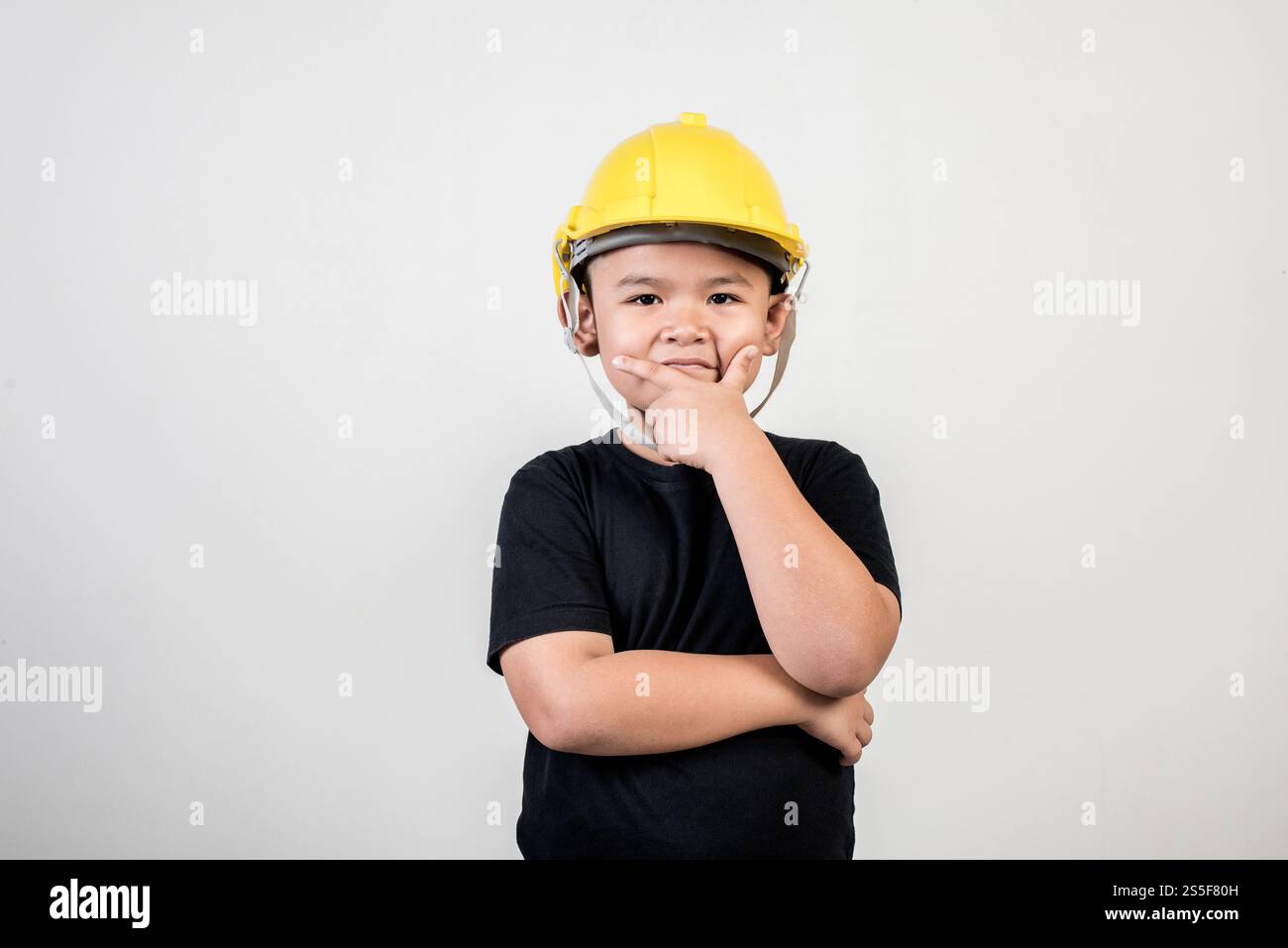 Portrait Happy boy wearing engineer hat Stock Photo - Alamy