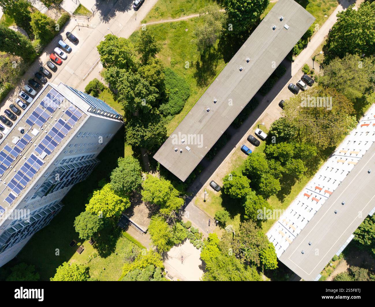Aerial view of a modern building with a solar-paneled roof beside ...