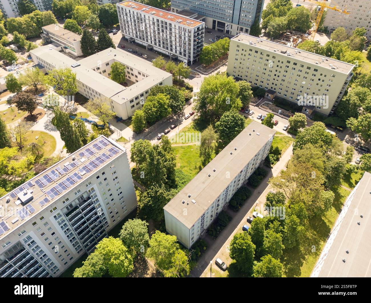 Aerial view of a modern building with a solar-paneled roof beside ...