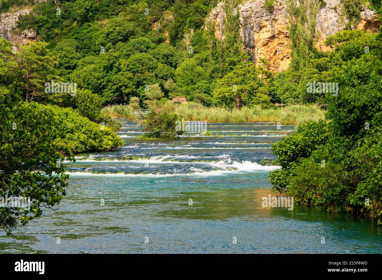Flanked lush trees towering cliff hi-res stock photography and images ...