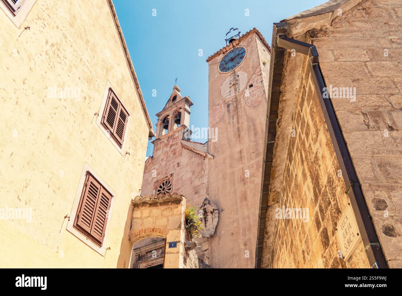 Historic buildings with shuttered windows flank narrow streets leading ...