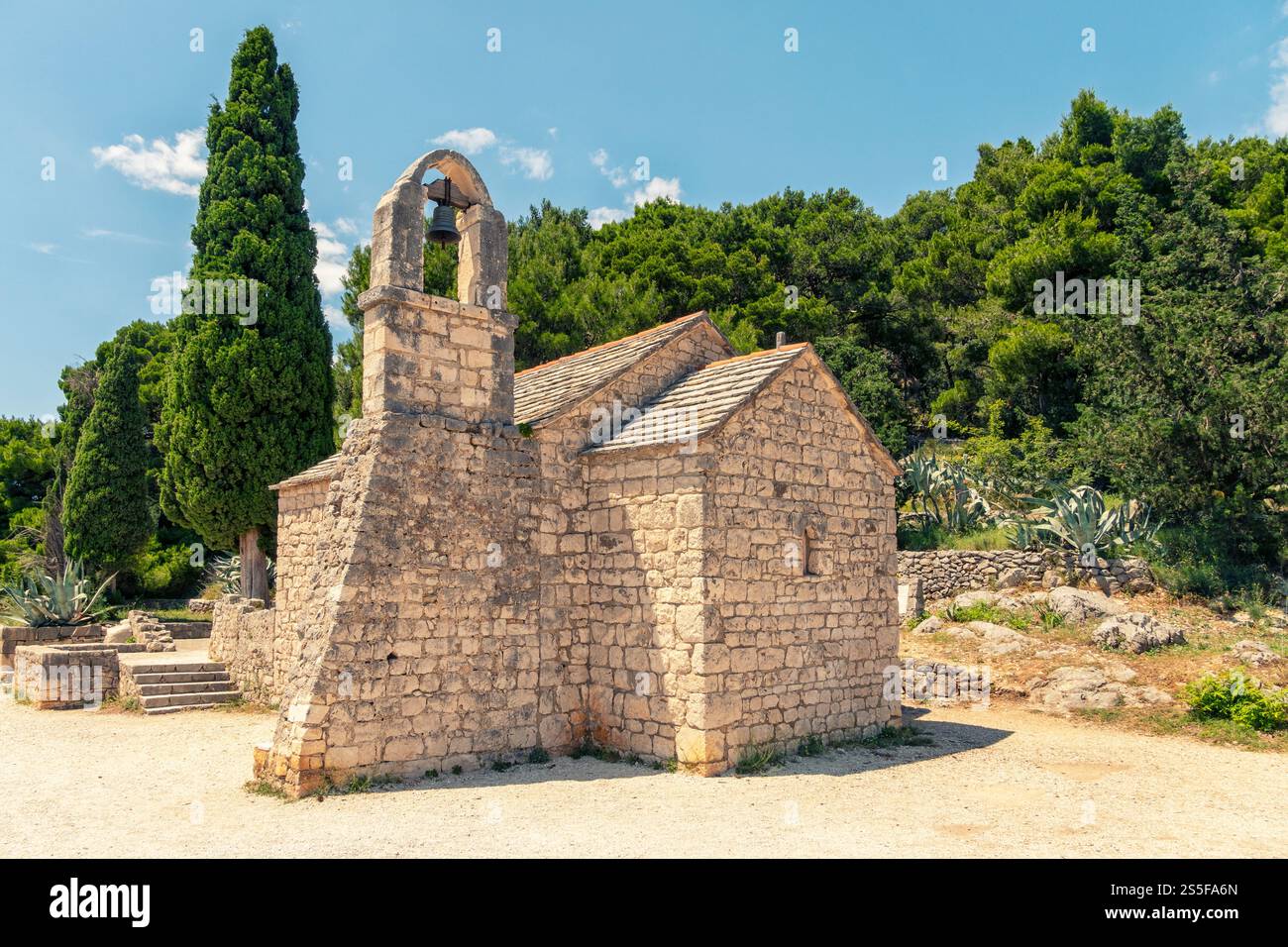 Old stone church of St. Nicholas with a bell tower under clear blue sky ...