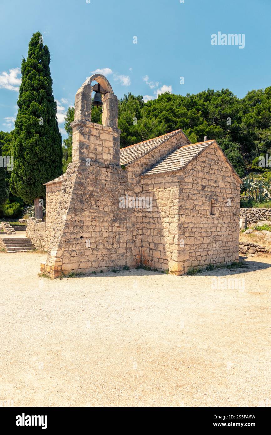 Old stone church of St. Nicholas with a bell tower under clear blue sky ...