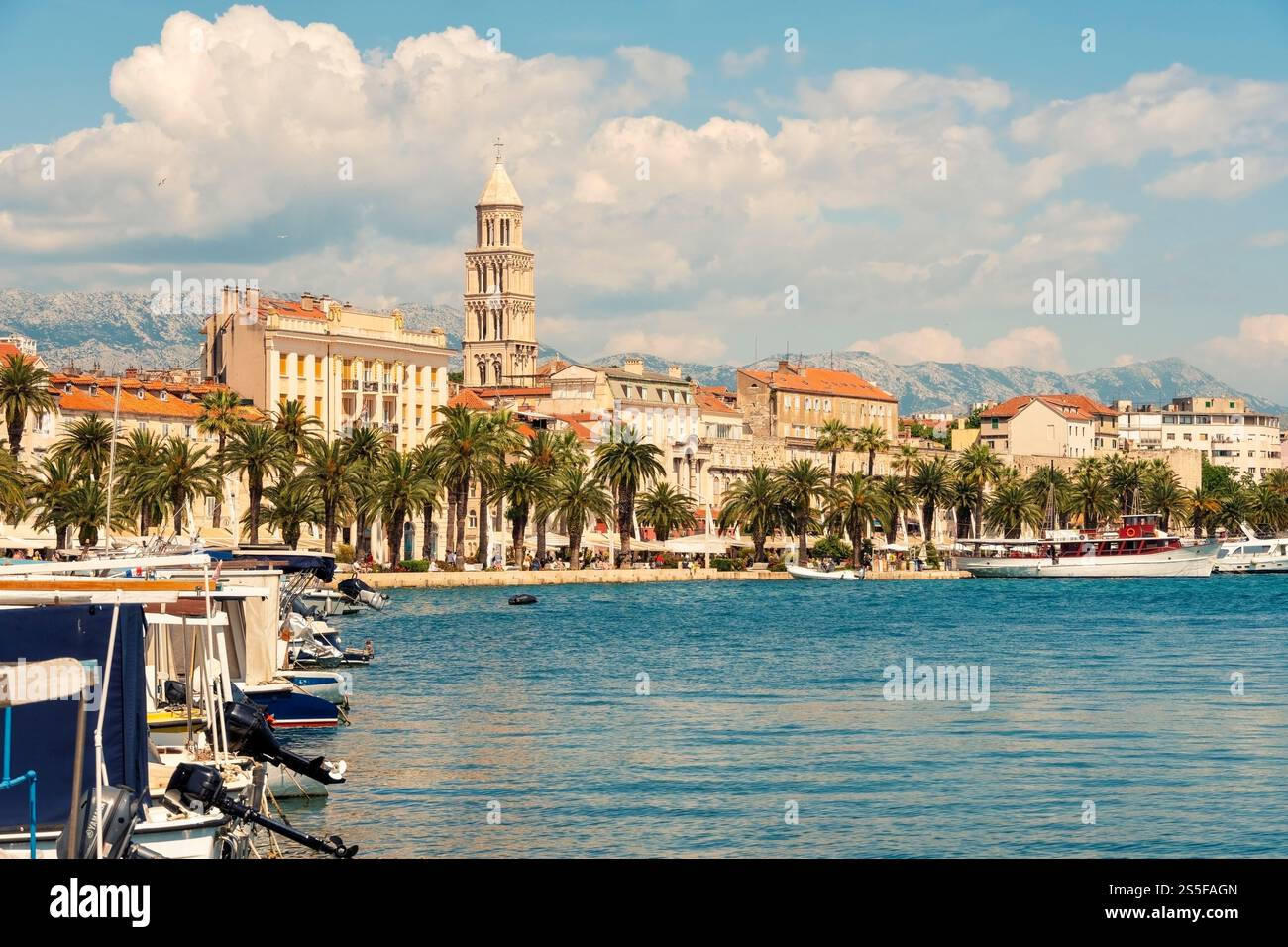 Coastal cityscape with historic architecture and moored boats under a ...